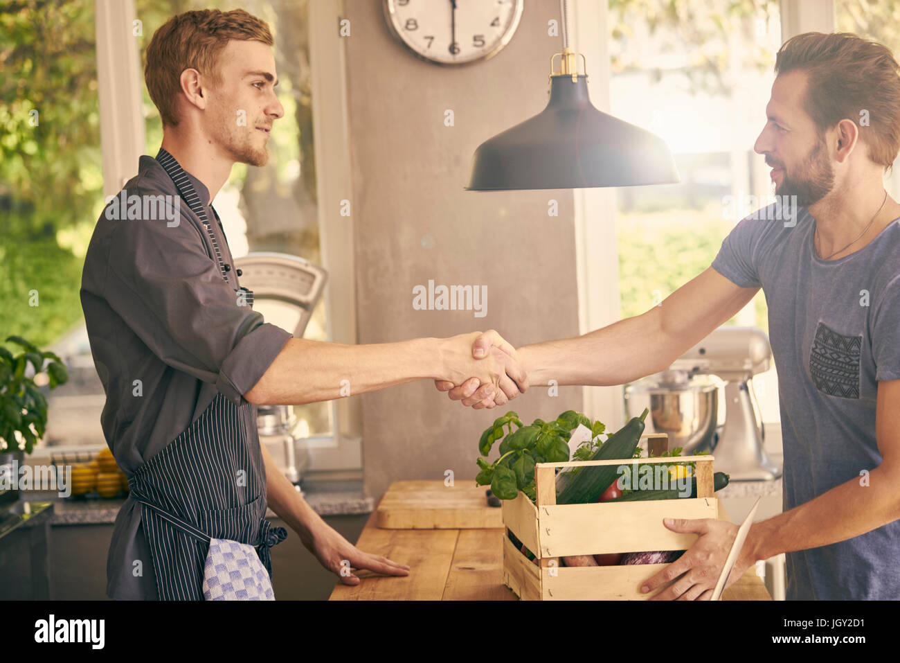 Chef and vegetable delivery man shaking hands Stock Photo - Alamy