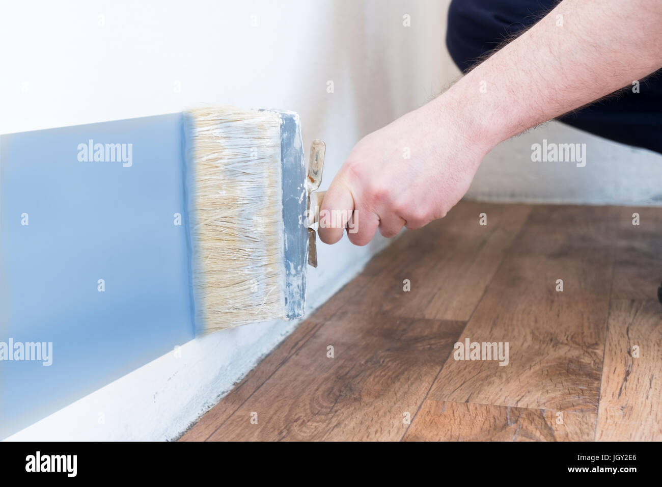 Professional painter worker is painting a wall Stock Photo - Alamy
