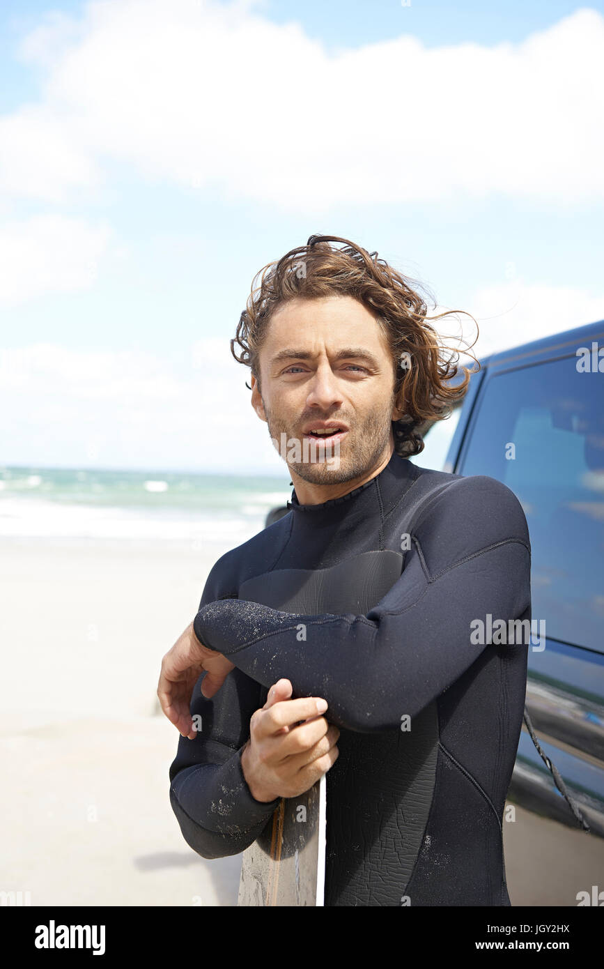 Kite surfer in wetsuit with surf board, Hornbæk, Hovedstaden, Denmark ...