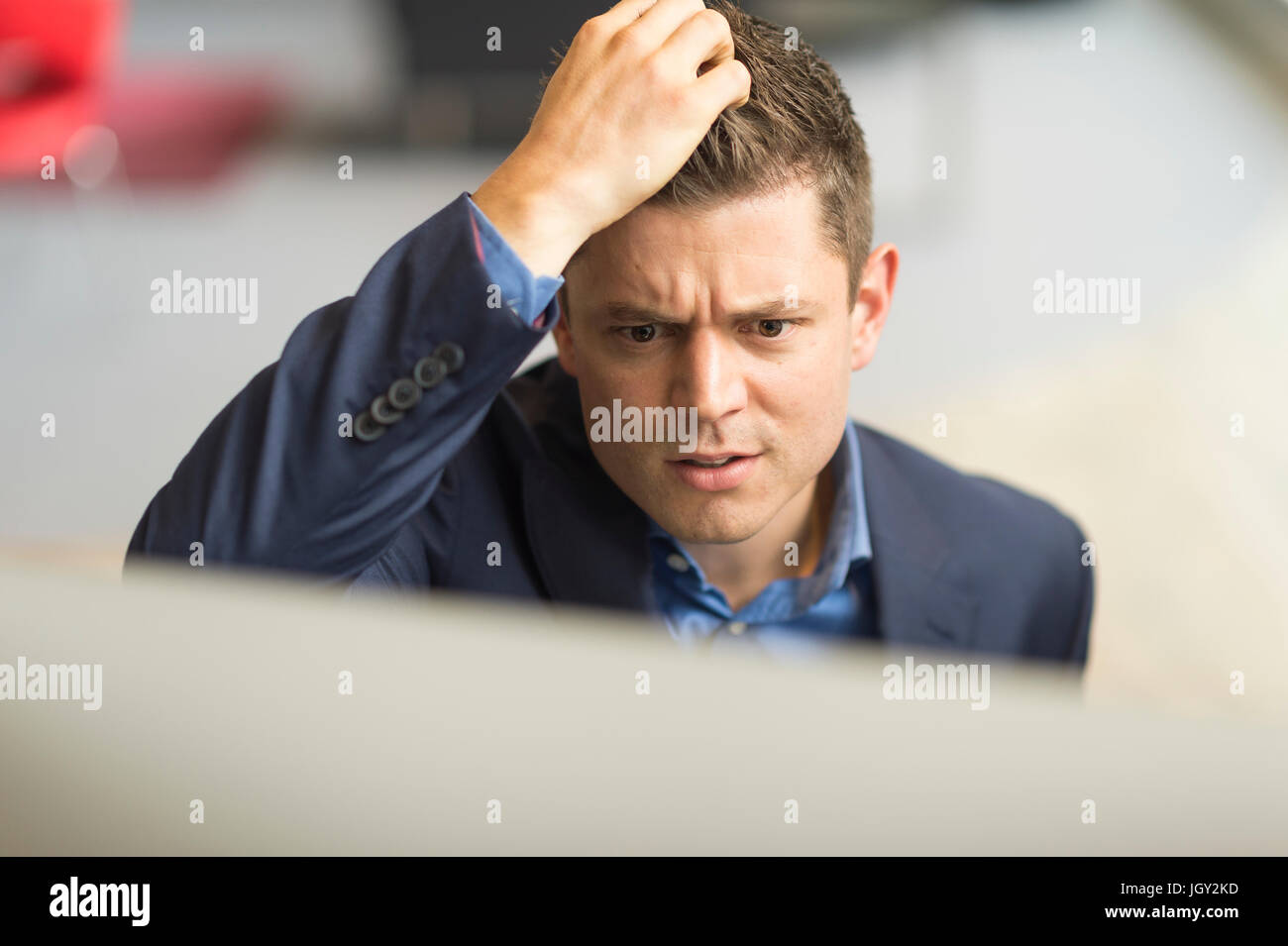 Man scratching head in office hi-res stock photography and images - Alamy