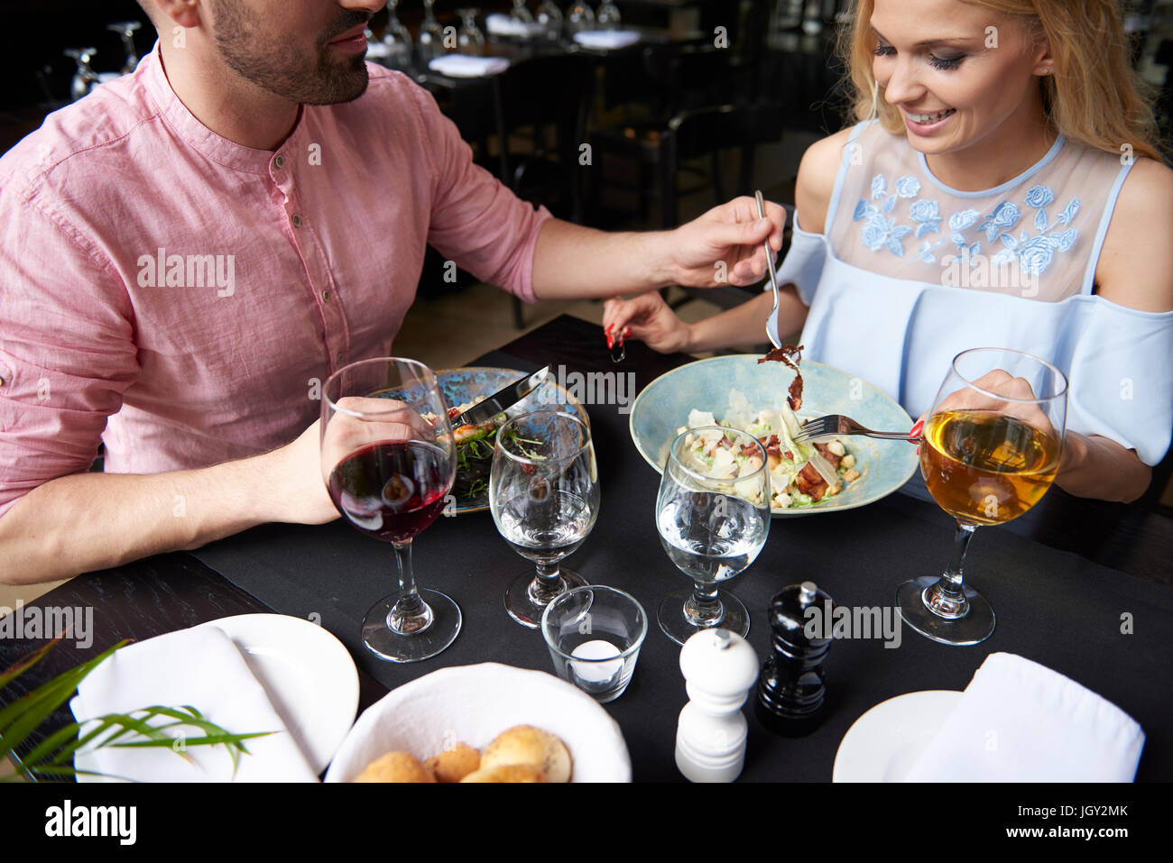 Man taking trying food girlfriend's lunch at restaurant table Stock ...