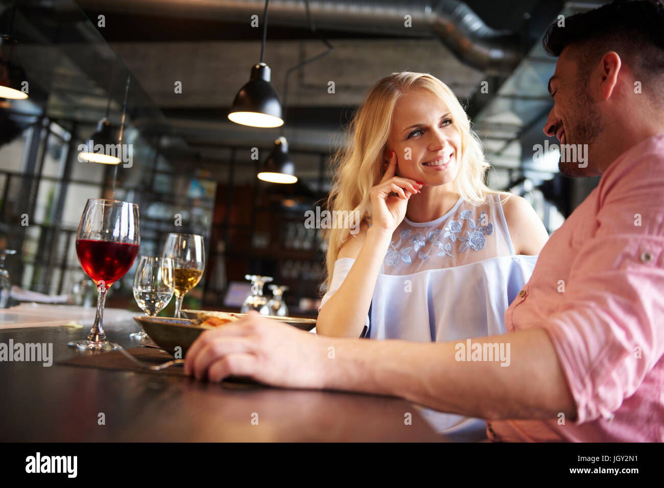 Couple chatting at restaurant table Stock Photo - Alamy