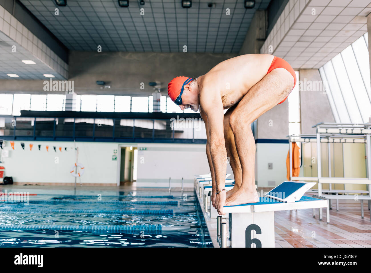 Senior man in position to dive into pool Stock Photo - Alamy