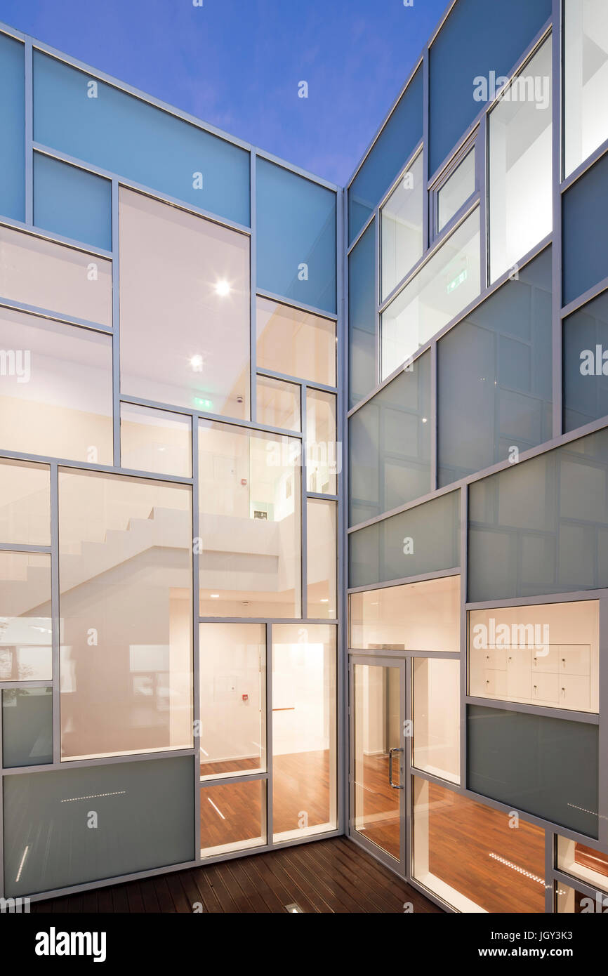 Dusk elevation of geometric courtyard facade. Marubi National Museum of ...