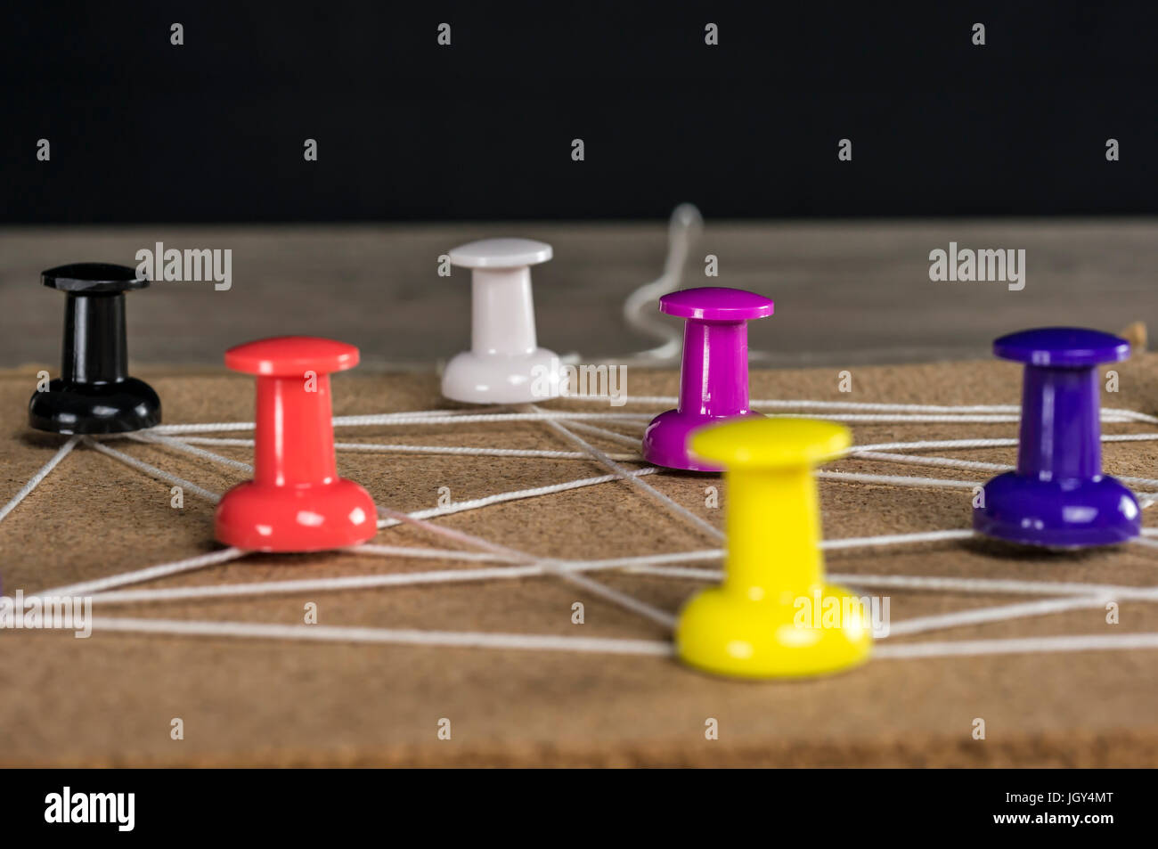 String placed on colorful pins forming a network Stock Photo - Alamy