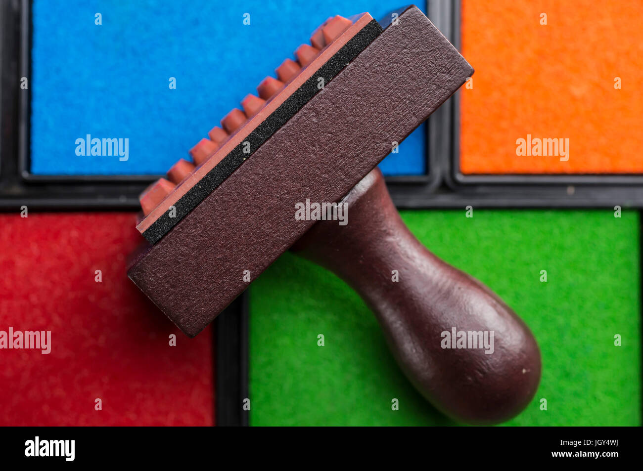 Close up shot of rubber stamp and multiple colors of ink boxes Stock ...