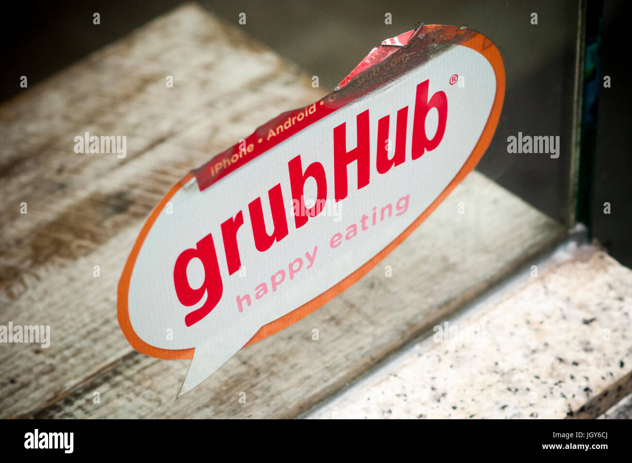A worn sticker for the GrubHub internet food delivery service is seen ...
