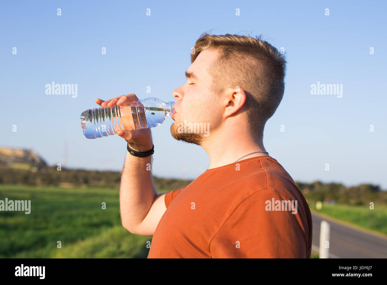 Muscular men drinking water from hi-res stock photography and images ...