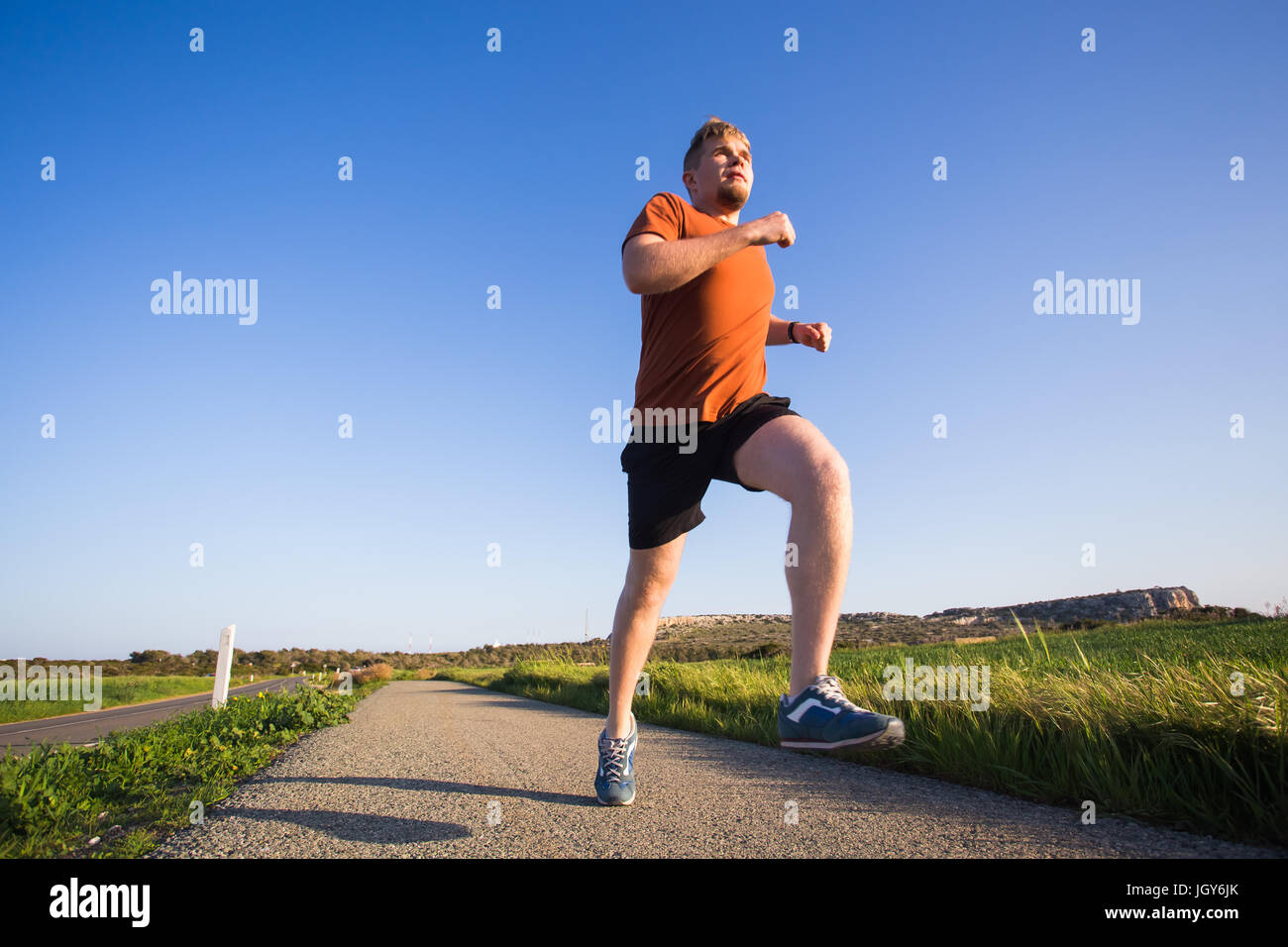 Man running outdoor sprinting for success. Male fitness runner sport ...