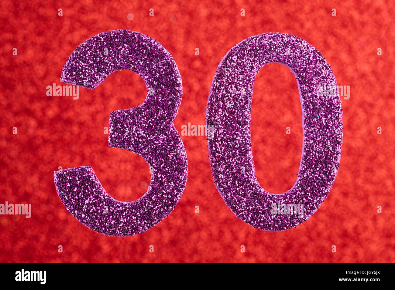 Number thirty purple color over a red background. Anniversary ...