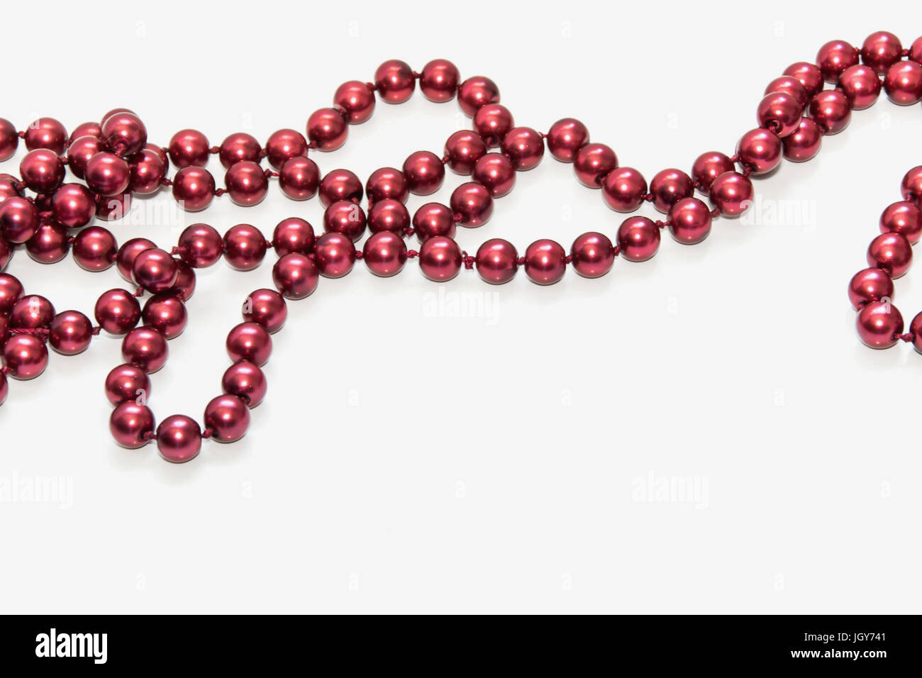 Red pearl necklace on white background Stock Photo - Alamy