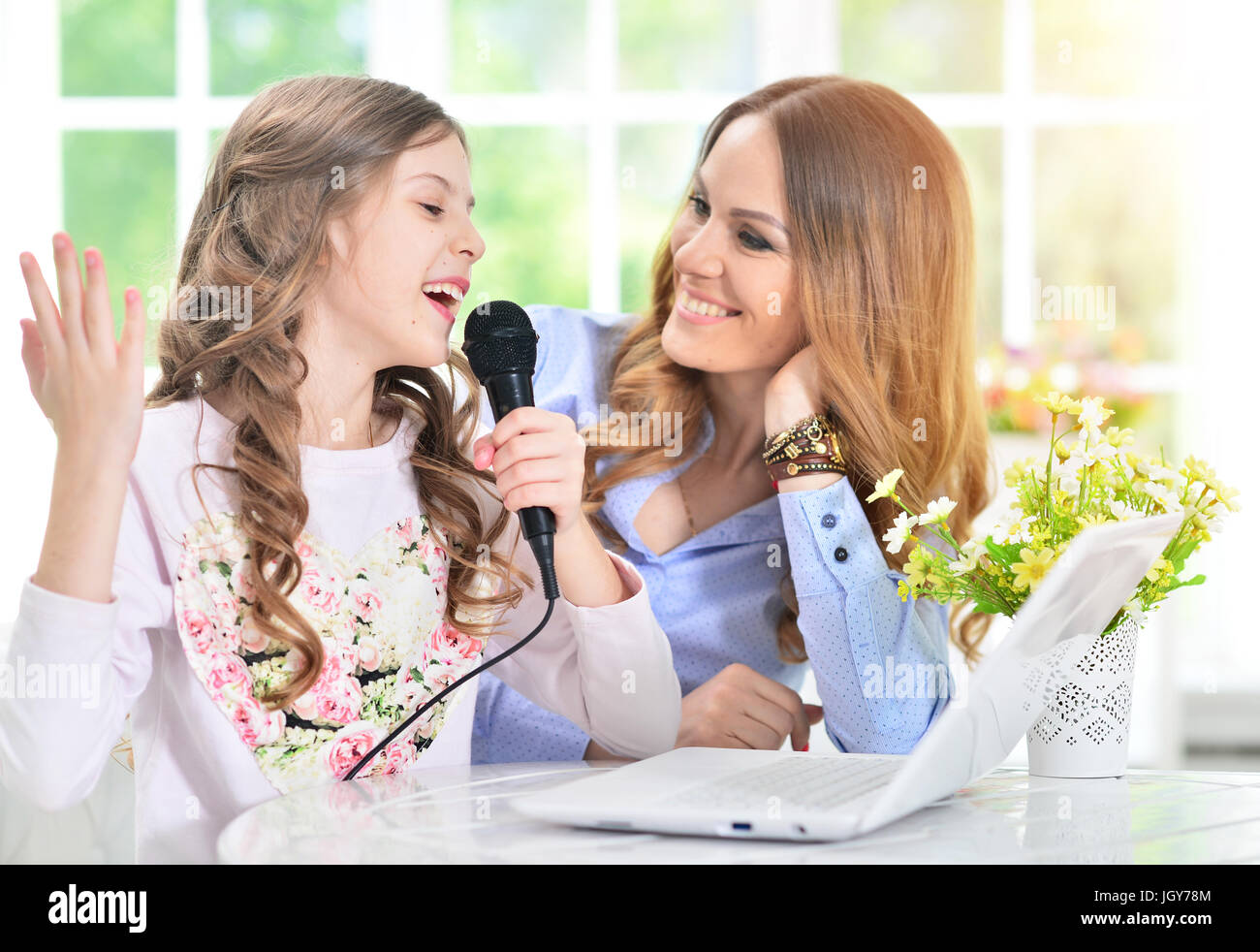 woman and girl singing karaoke Stock Photo - Alamy