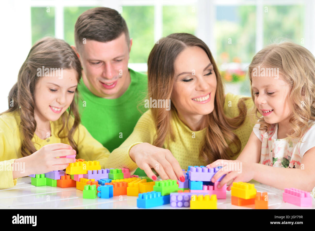 Family collecting blocks together Stock Photo - Alamy