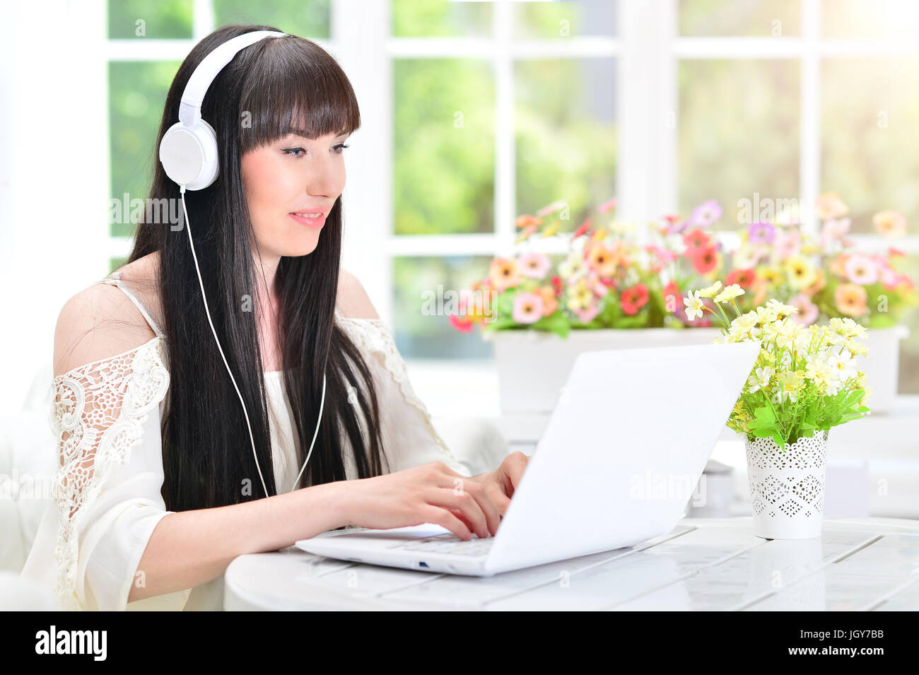 woman in headphones using laptop Stock Photo - Alamy