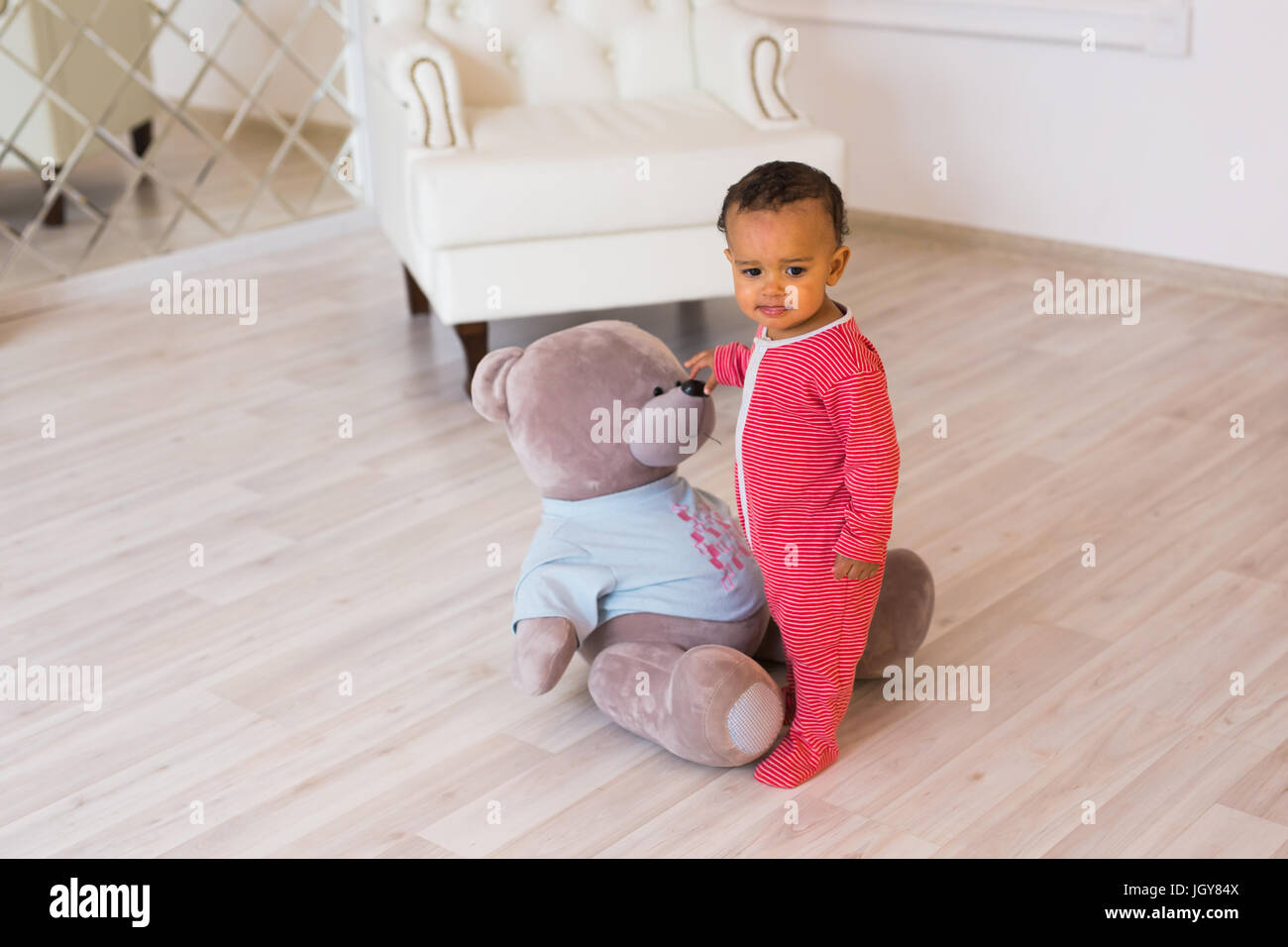 Happy baby boy playing with his teddy bear Stock Photo - Alamy