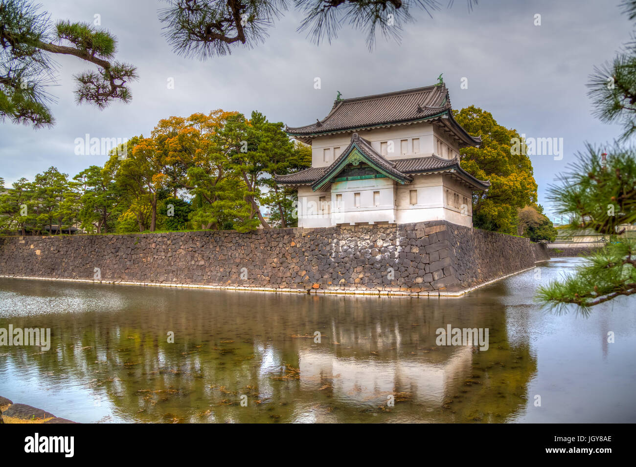 The Imperial Palace buildings reflected in the moat in Tokyo, Japan ...