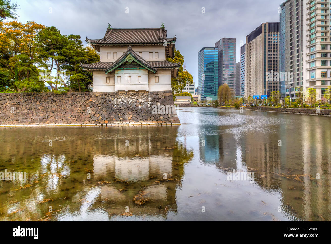 The Imperial Palace buildings reflected in the moat in Tokyo, Japan ...