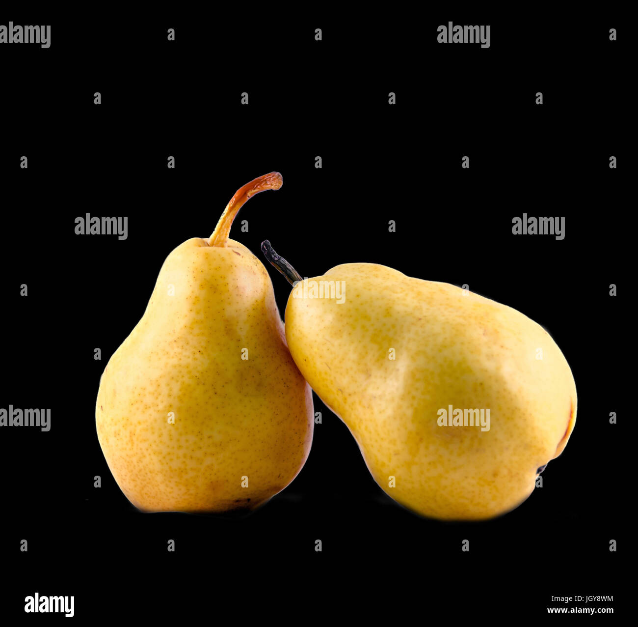 Yellow pears fruits close up, black background Stock Photo - Alamy