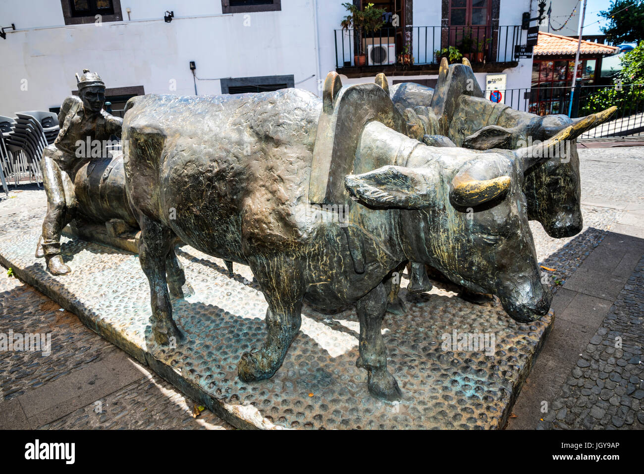 Bronze Statue of Oxen and their Driver pulling goods on wooden runners ...