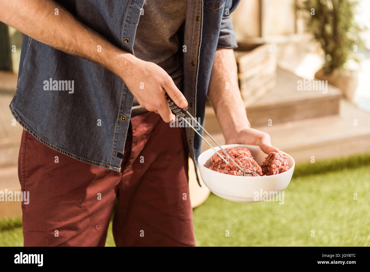 cropped view of man preparing raw meat for burgers outdoors Stock Photo ...