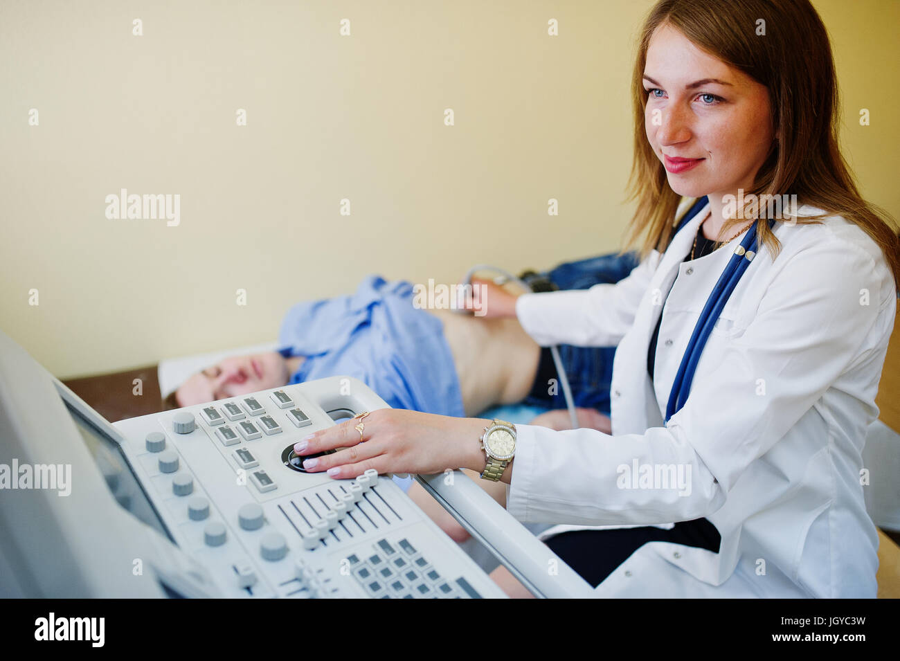 Beautiful young doctor doing diagnostic sonography on a patient Stock ...