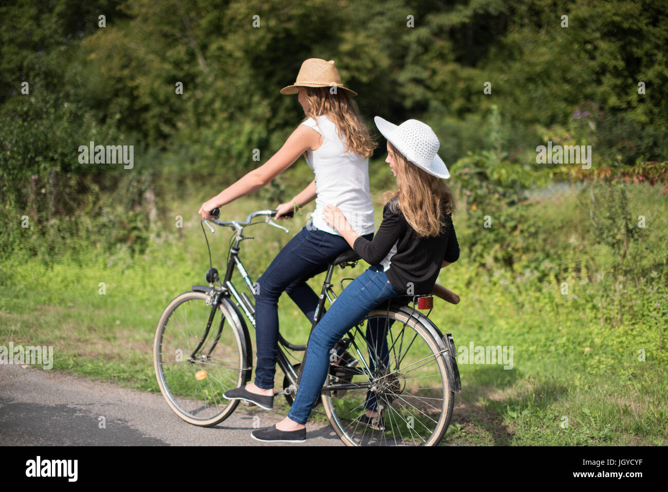 Two girls on bike hi-res stock photography and images - Alamy