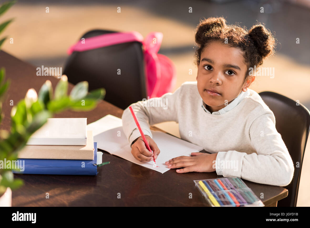 african american schoolgirl doing homework, african student concept ...