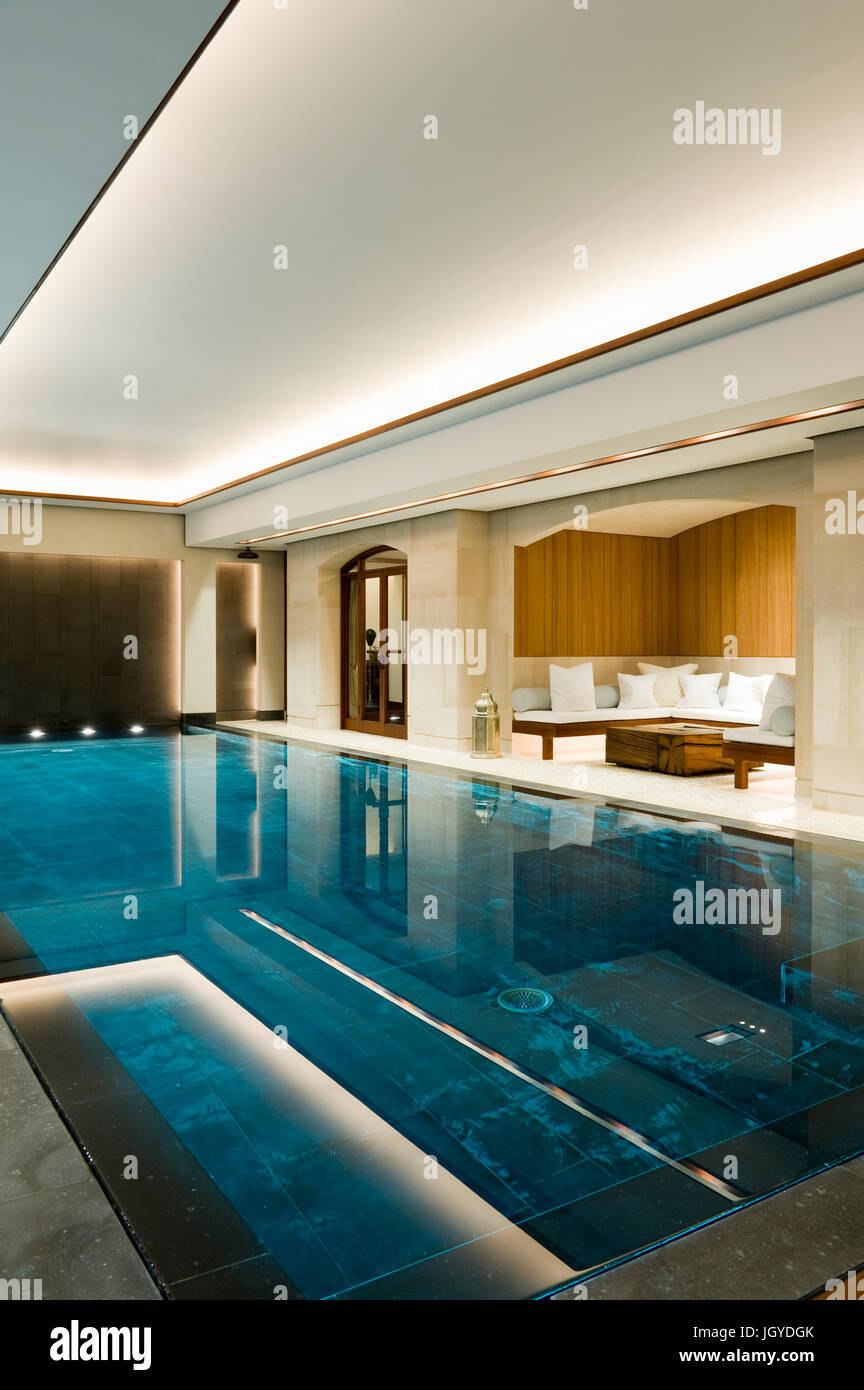 Indoor swimming pool with recessed seating area Stock Photo - Alamy