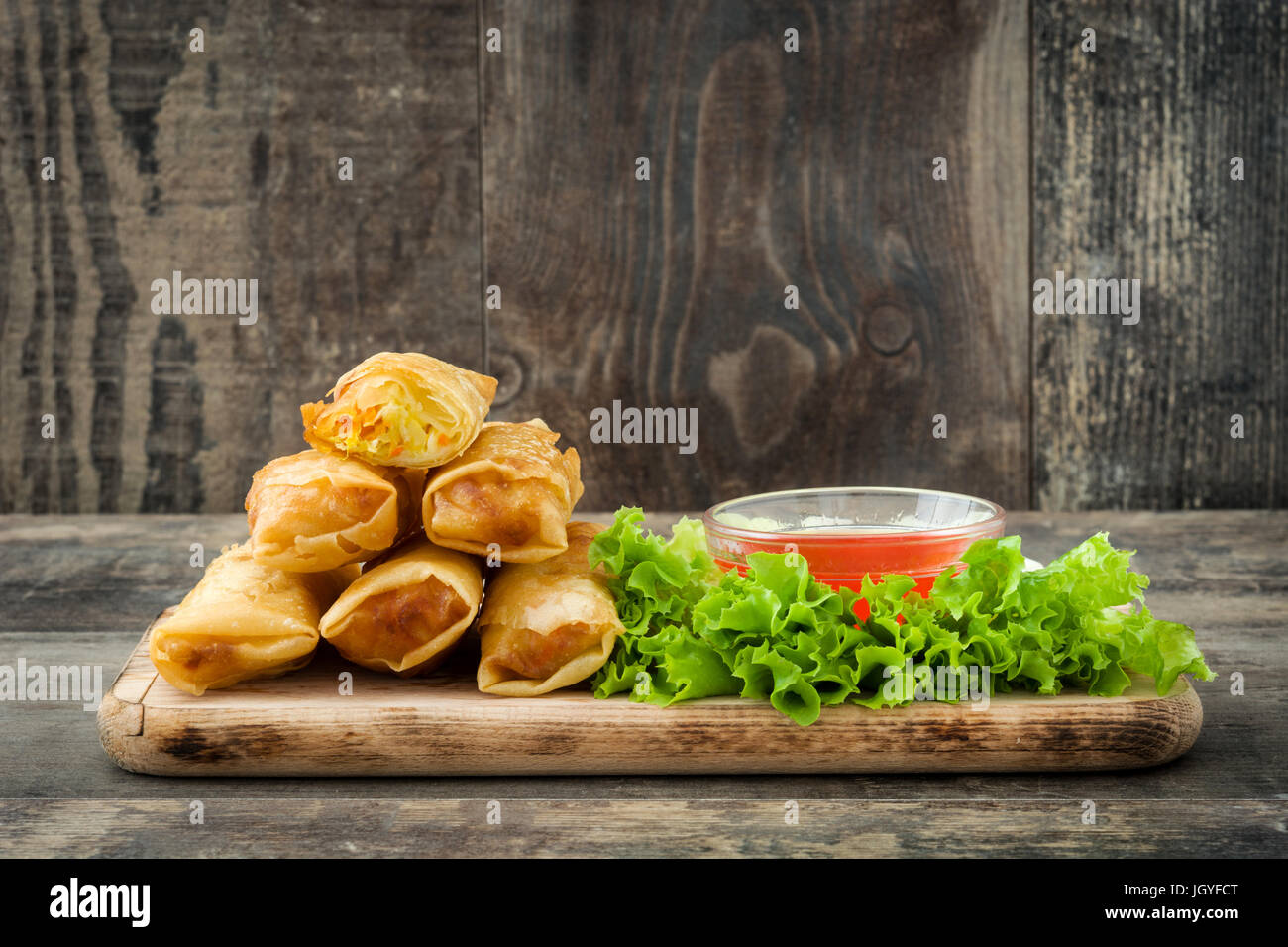 Vegetable spring rolls on wooden table background Stock Photo - Alamy