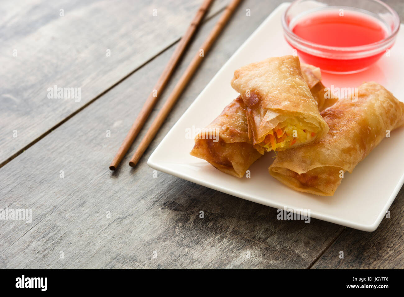 Vegetable spring rolls on wooden table background Stock Photo - Alamy