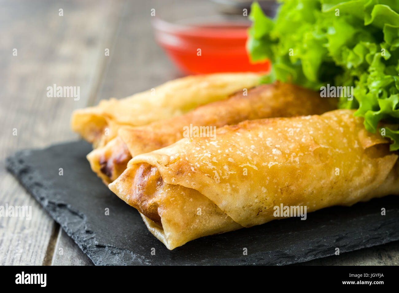 Vegetable spring rolls on black slate Stock Photo - Alamy