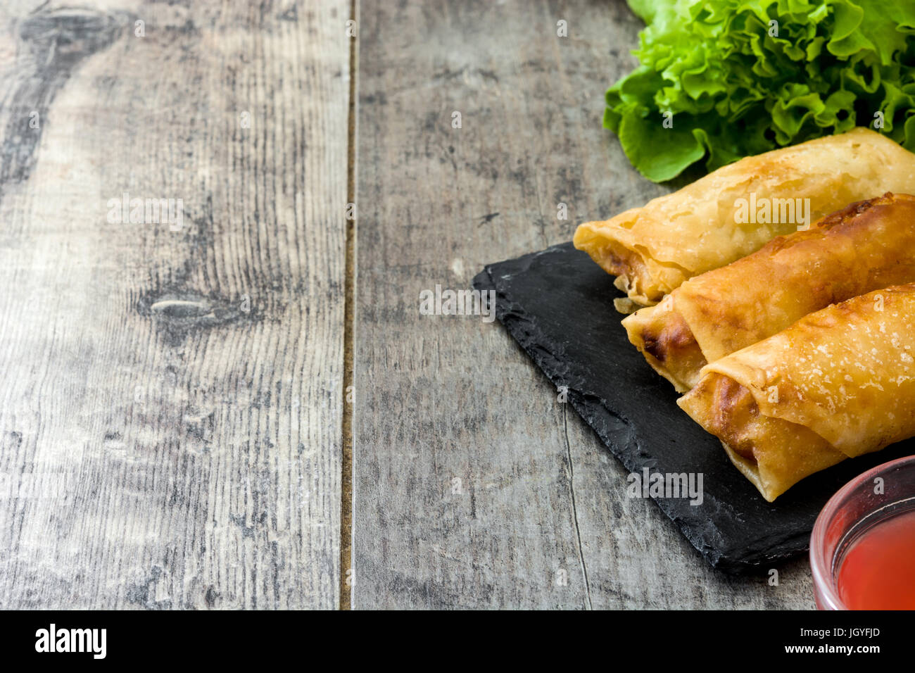 Vegetable spring rolls on wooden table background Stock Photo - Alamy