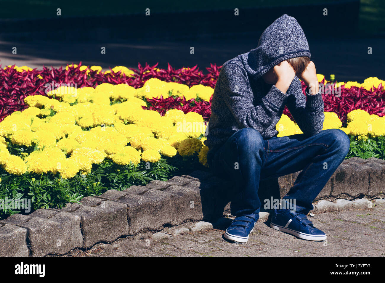Sad,disappointed child holding head with hands Stock Photo - Alamy