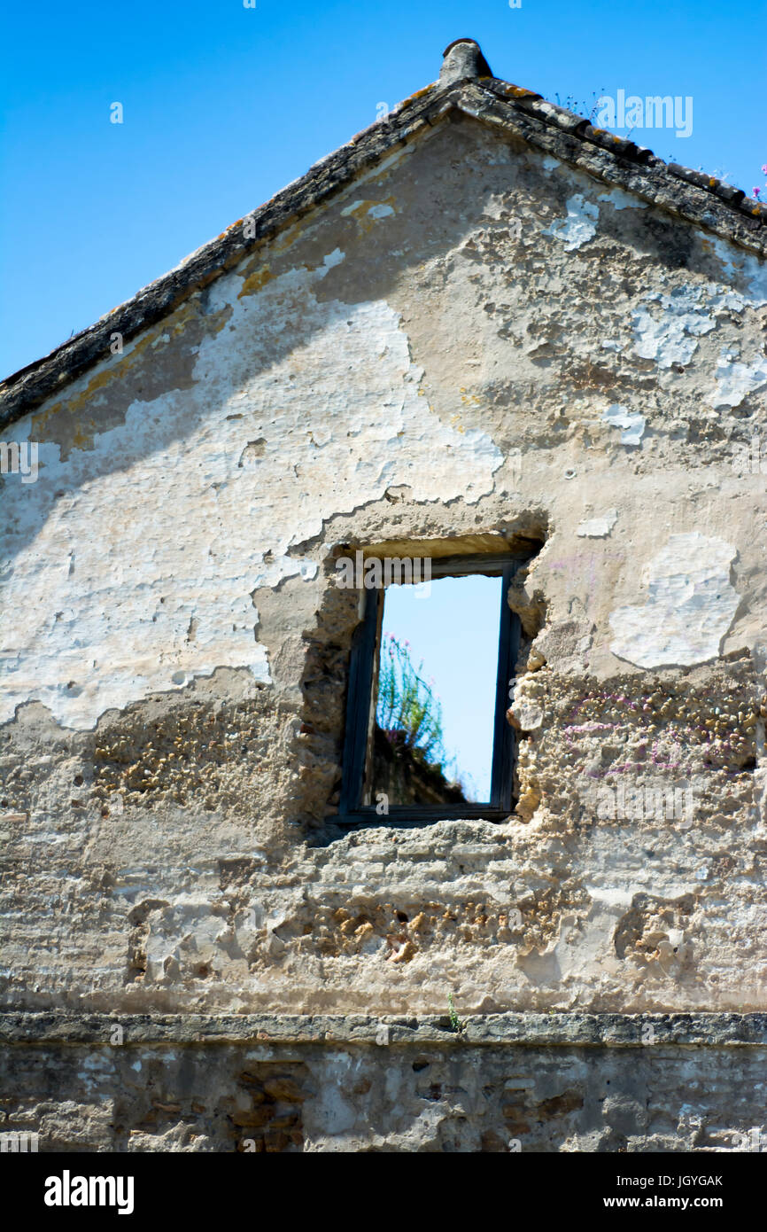 Ruined house window through which you can see the blue sky Stock Photo ...