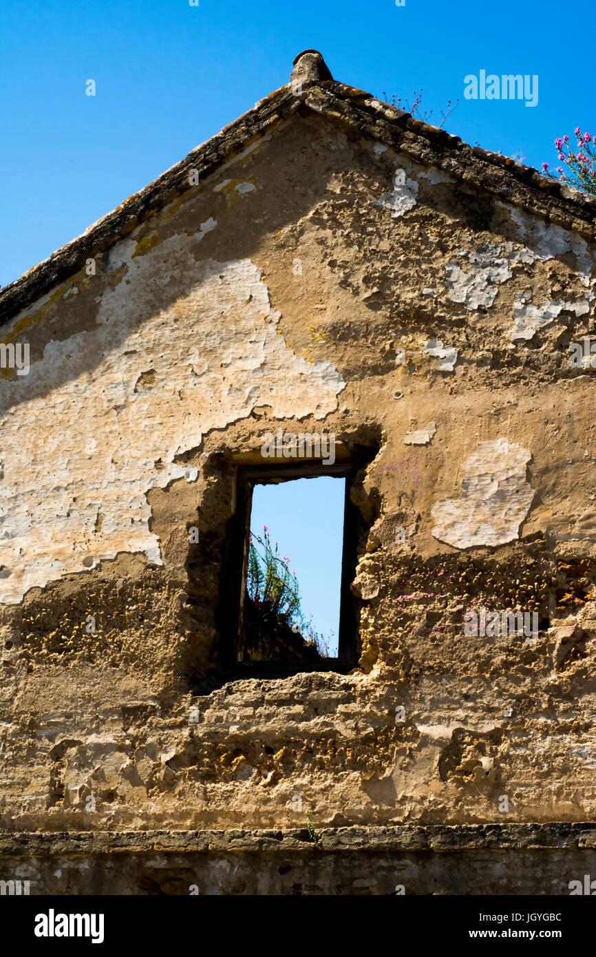 Ruined house window through which you can see the blue sky Stock Photo ...