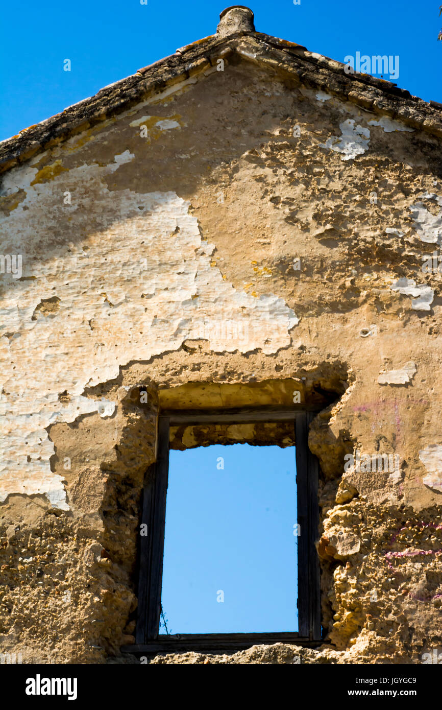 Ruined house window through which you can see the blue sky Stock Photo ...