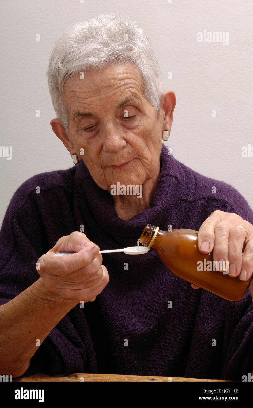 senior woman taking syrup Stock Photo - Alamy