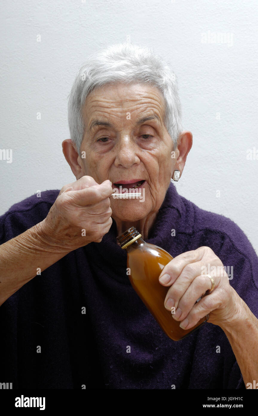 senior woman taking syrup Stock Photo - Alamy