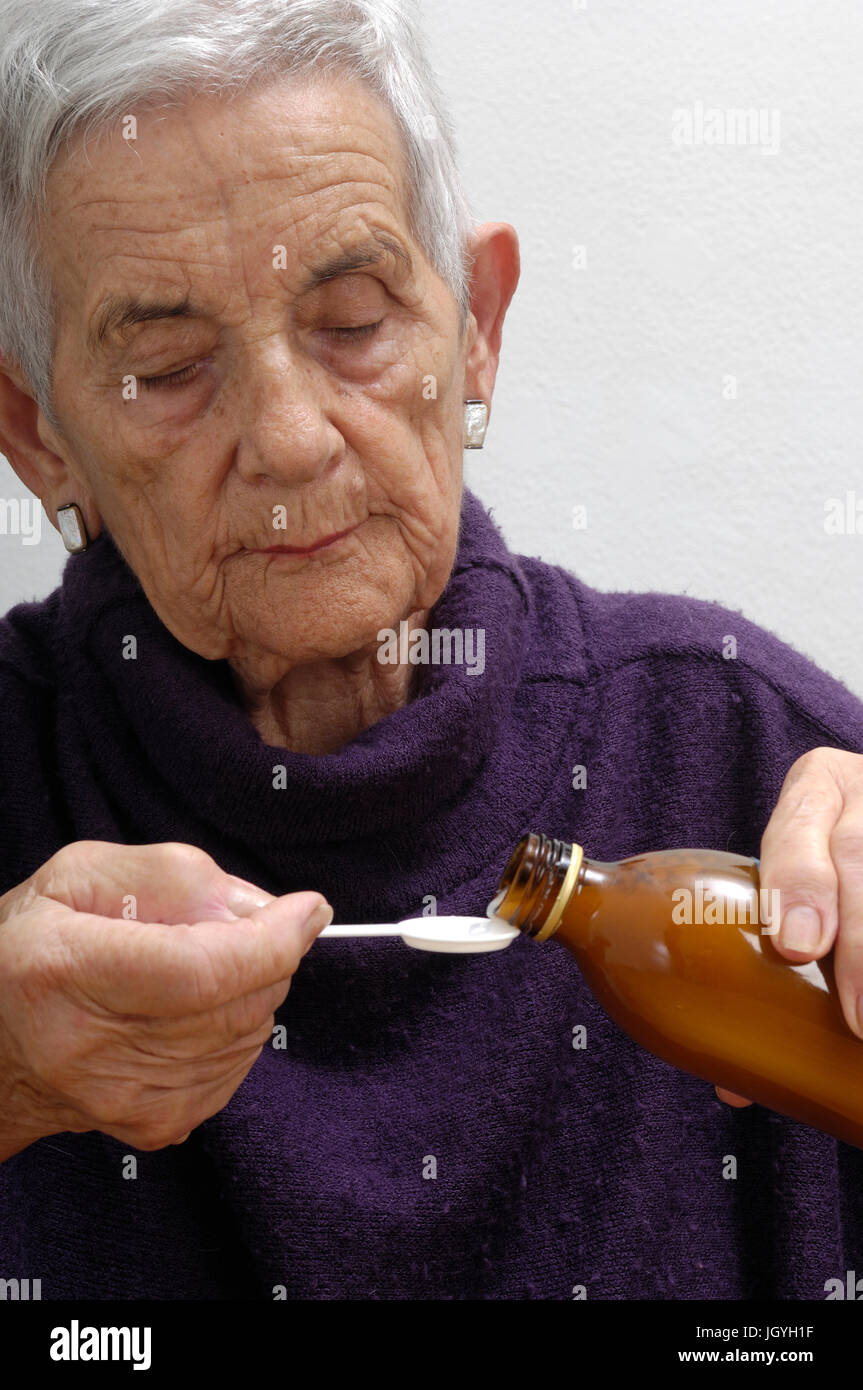 senior woman taking syrup Stock Photo - Alamy