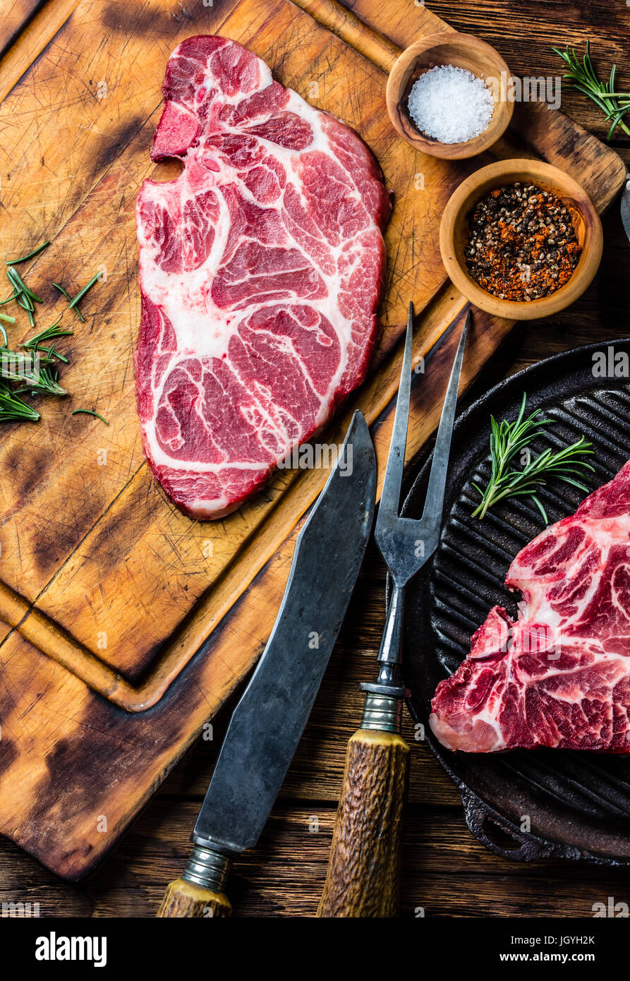 Raw marbled beef steaks on wooden cutting board. Top view Stock Photo ...