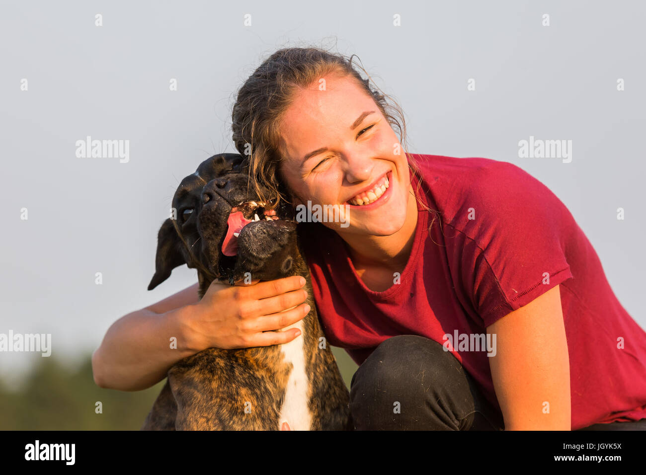 picture of a young girl who is hugging her boxer dog Stock Photo - Alamy