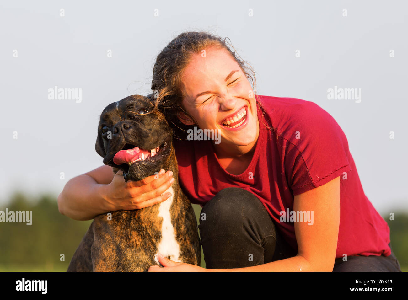 picture of a young girl who is hugging her boxer dog Stock Photo - Alamy