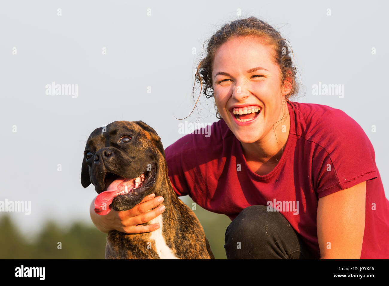 picture of a young girl who is hugging her boxer dog Stock Photo - Alamy