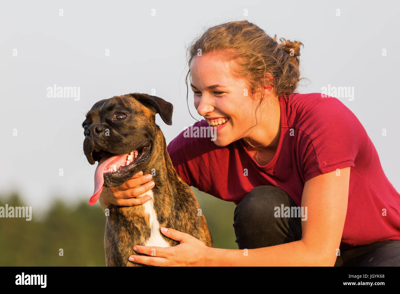 picture of a young girl who is hugging her boxer dog Stock Photo - Alamy