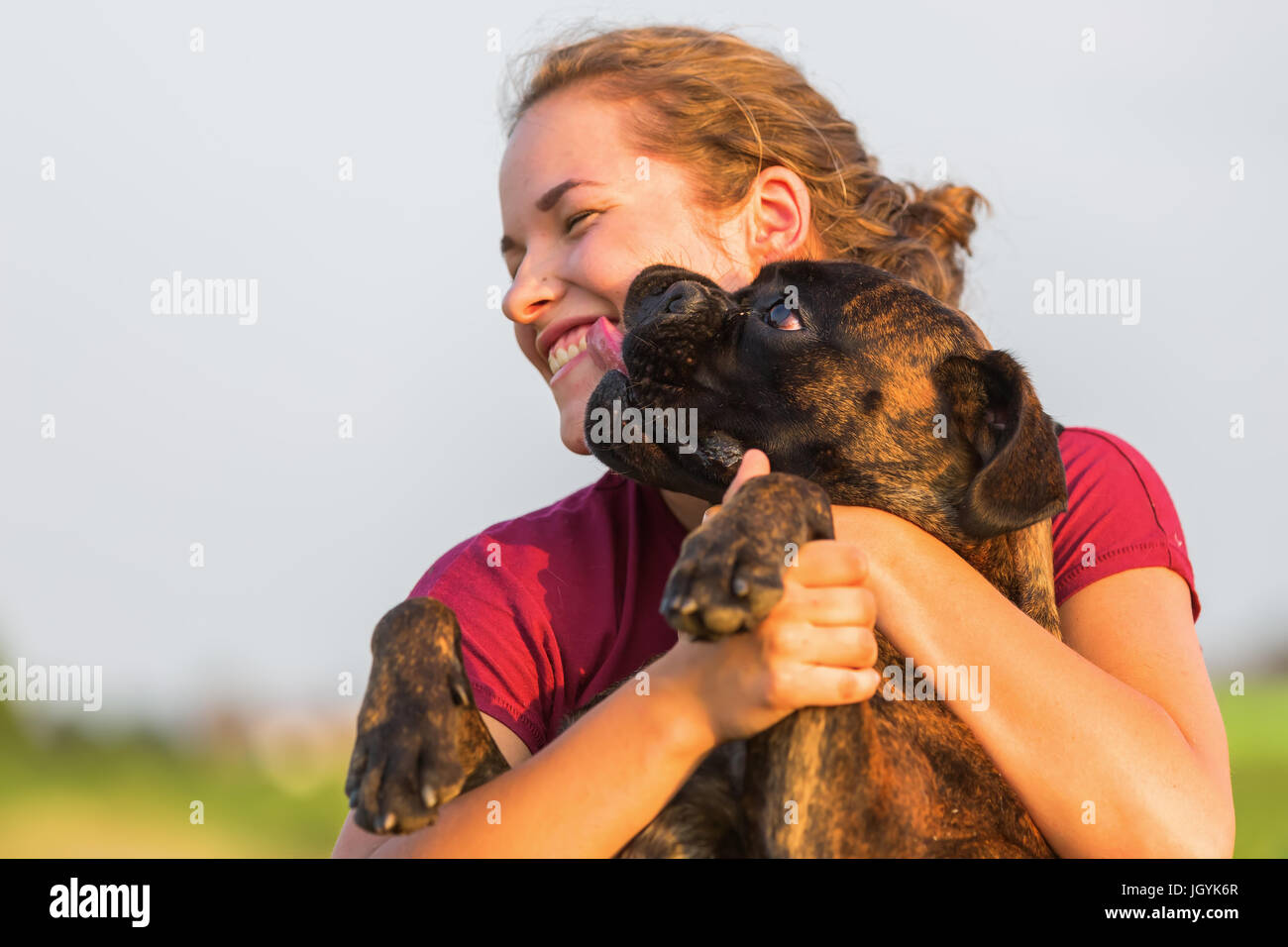 picture of a young girl who is hugging her boxer dog Stock Photo - Alamy