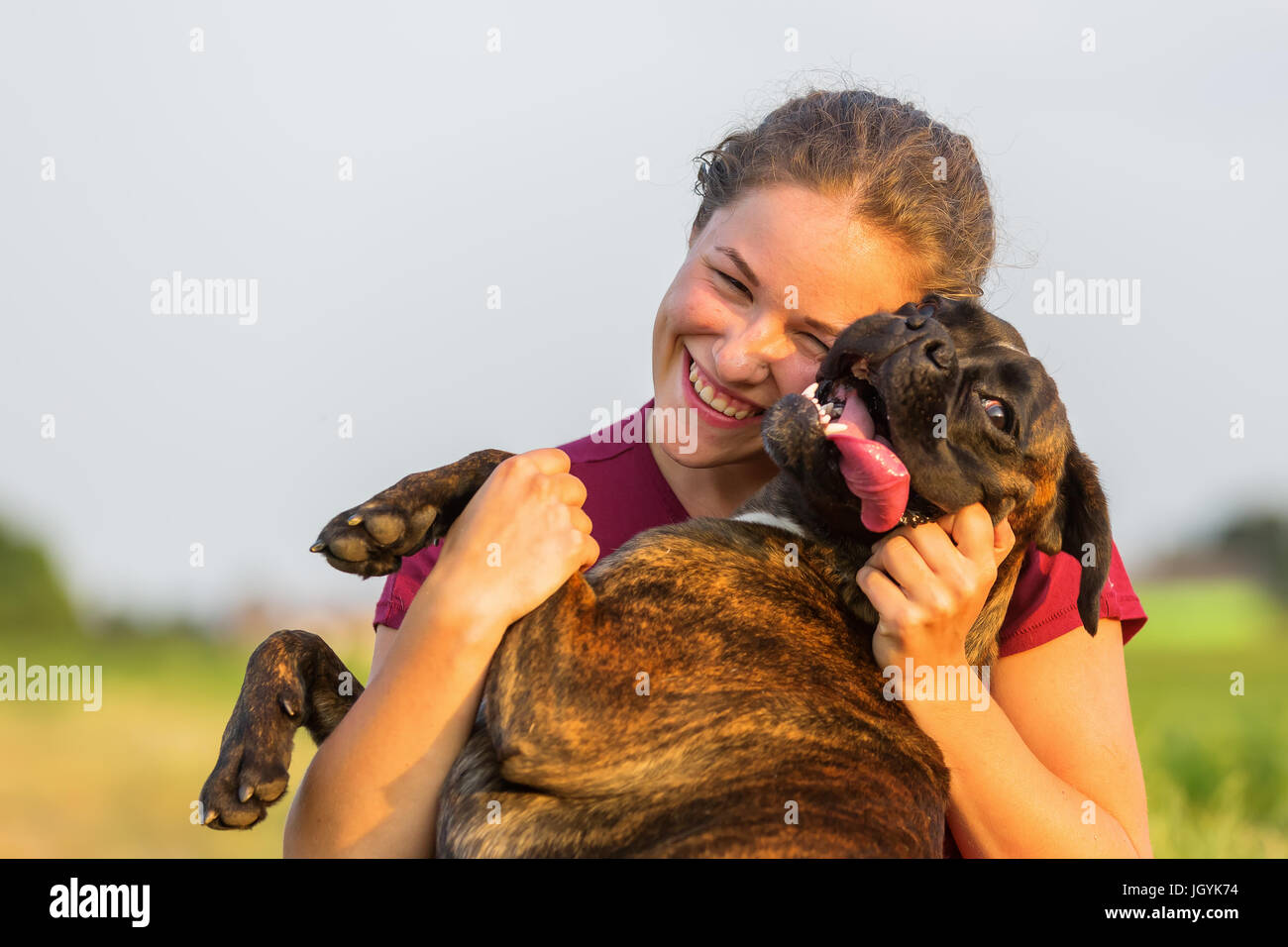 picture of a young girl who is hugging her boxer dog Stock Photo - Alamy