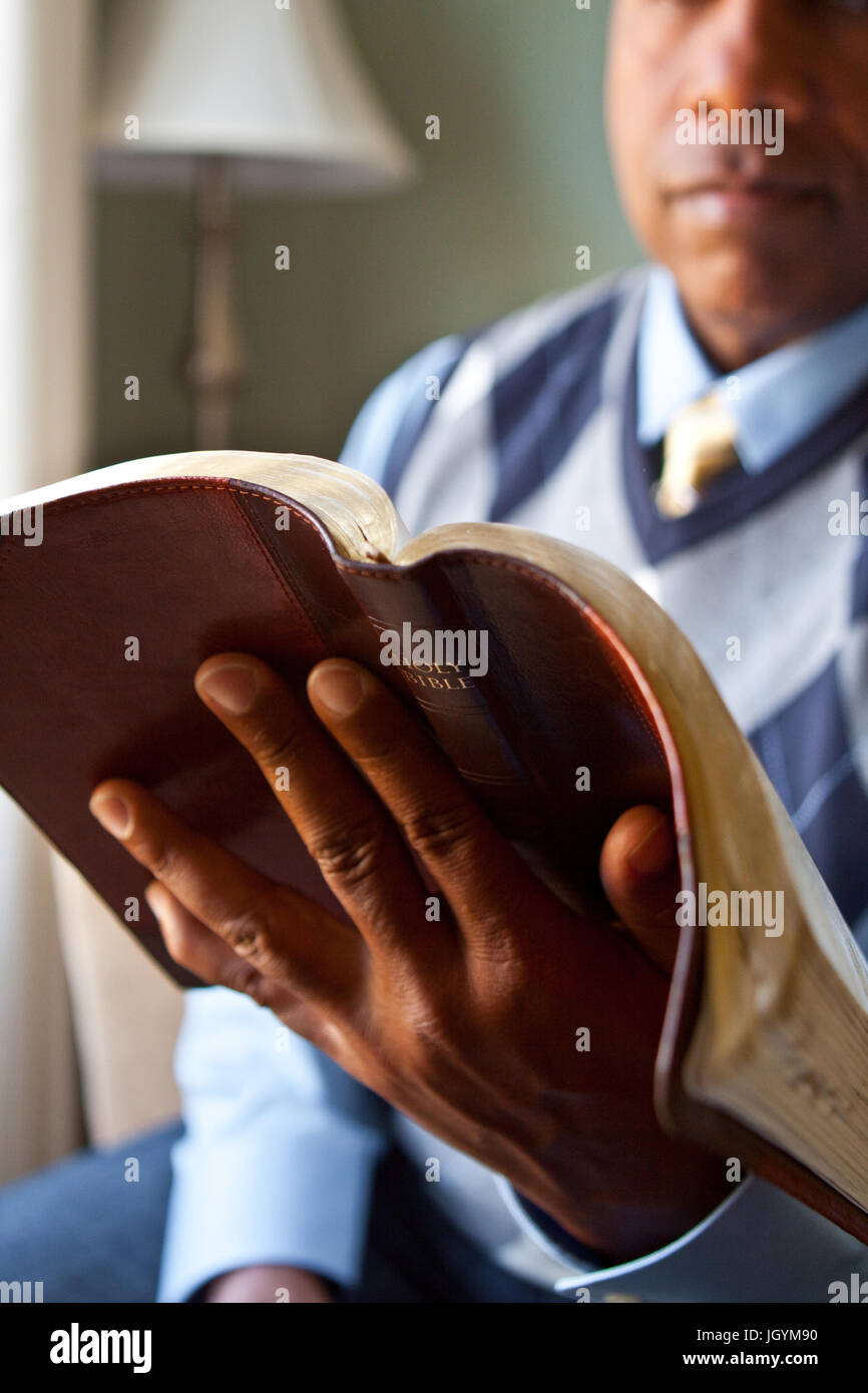 African American man reading the Bible at home Stock Photo - Alamy