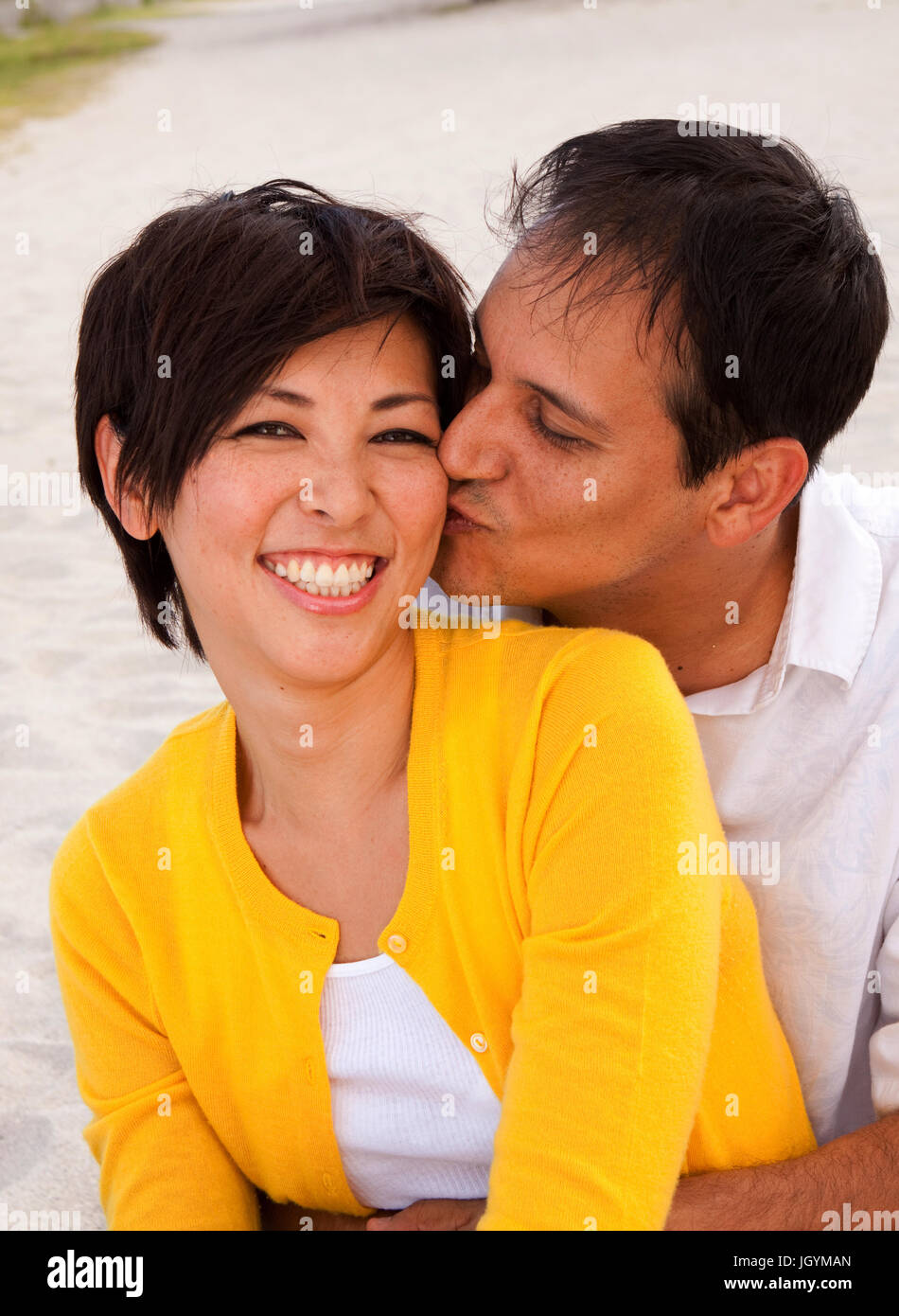Happy mixed race couple laughing and talking Stock Photo - Alamy