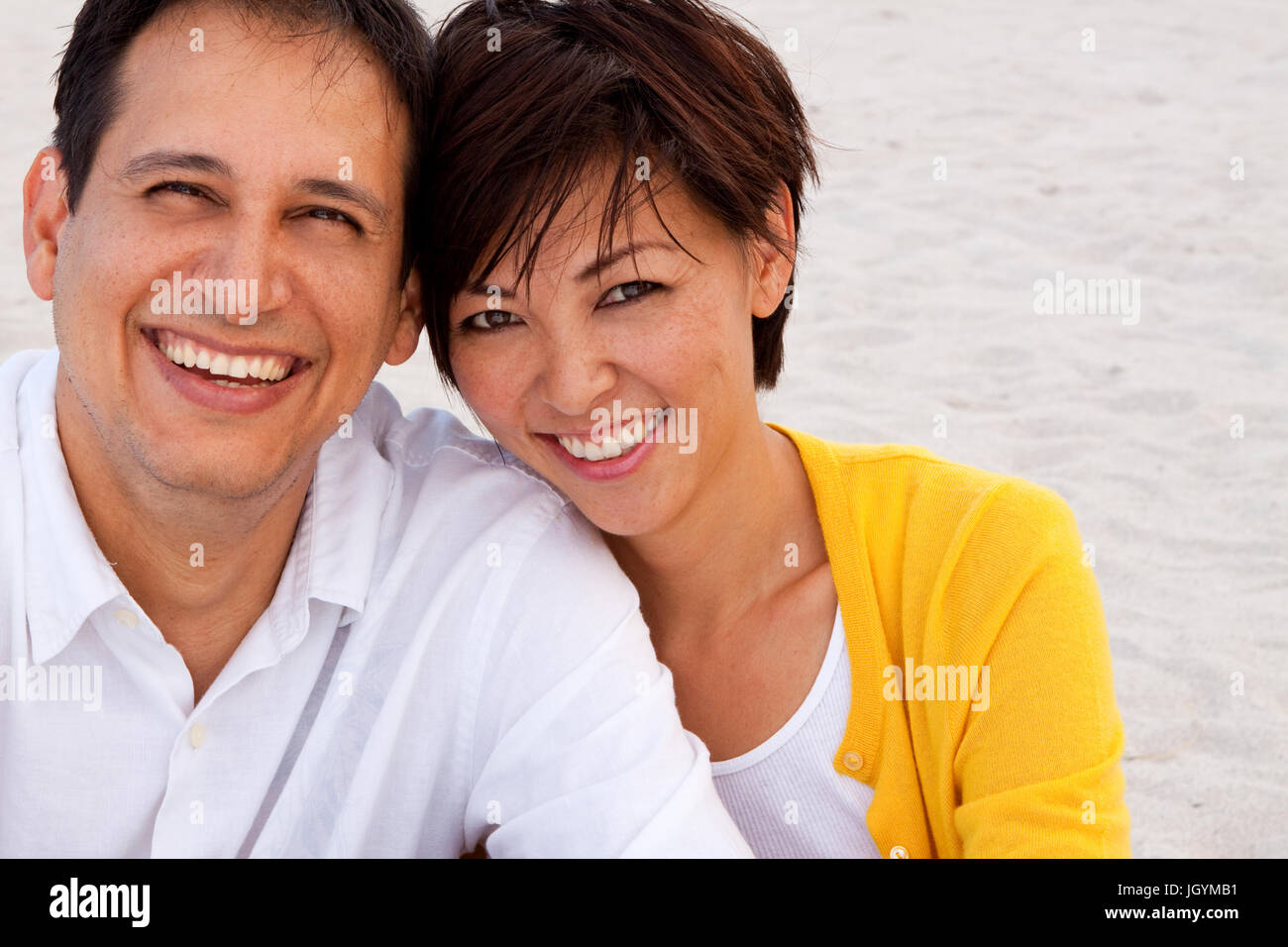 Happy mixed race couple laughing and talking Stock Photo - Alamy