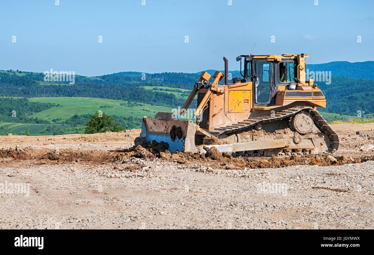 bulldozer a moving land shovel Stock Photo - Alamy